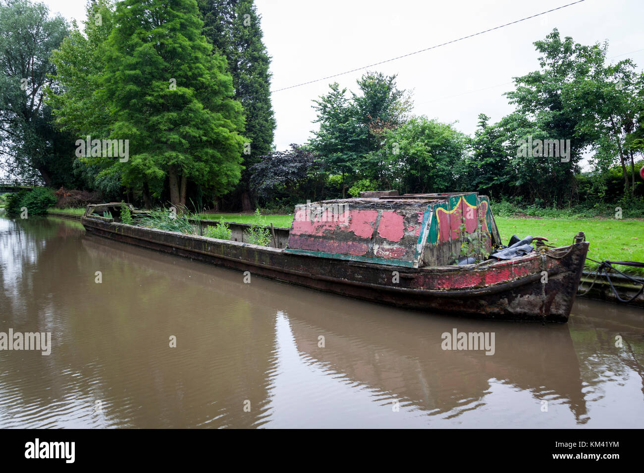 Old rusty and delapidated narrowboat moored on the Coventry canal ...