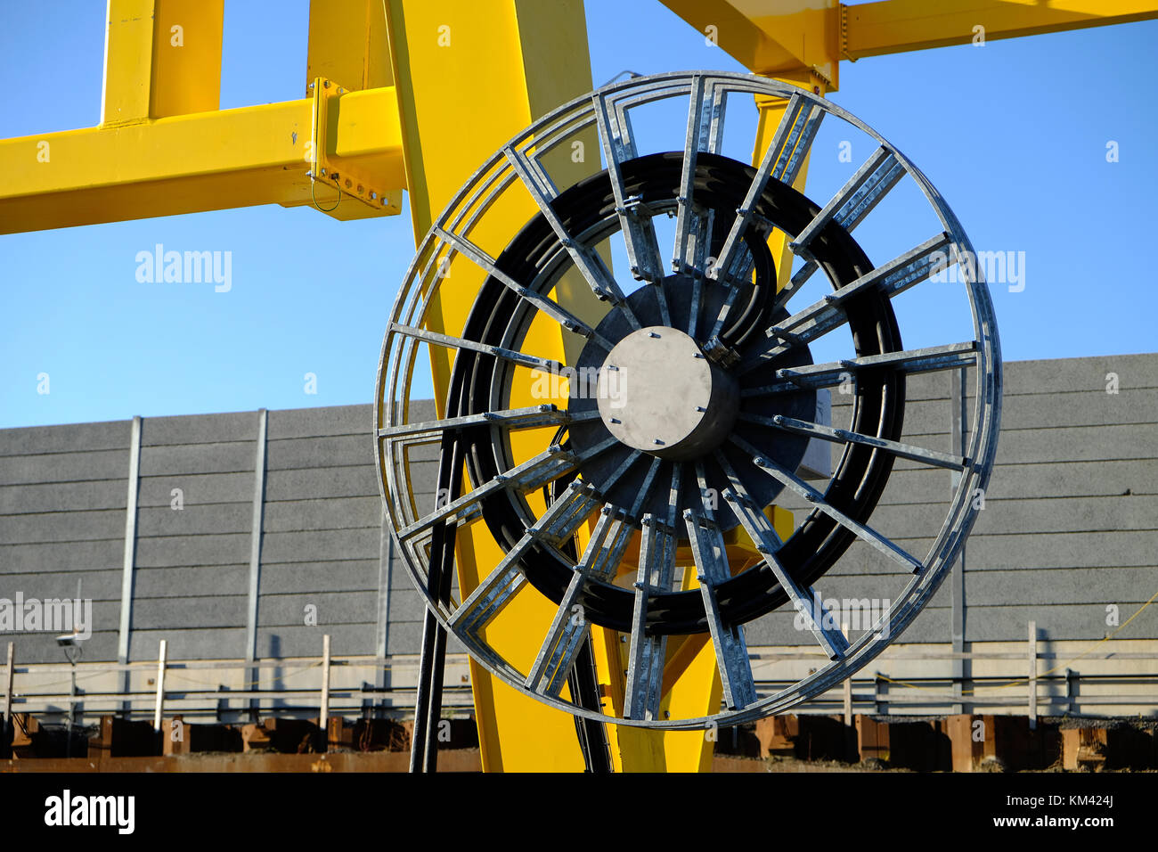 Large cable wheel in the front of yellow hoist Stock Photo - Alamy