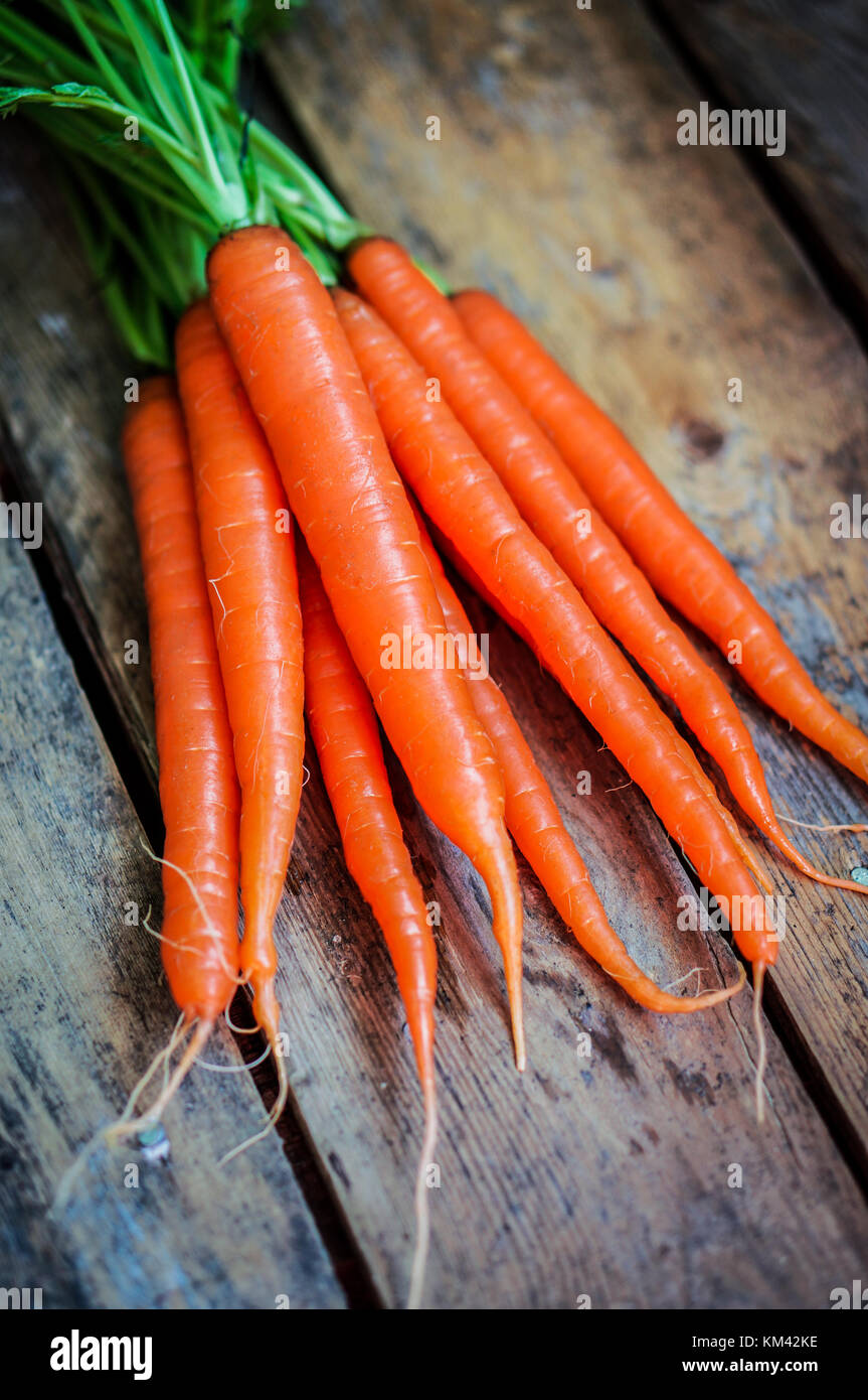 Farm Raised Organic Carrots On Wooden Background Stock Photo - Alamy