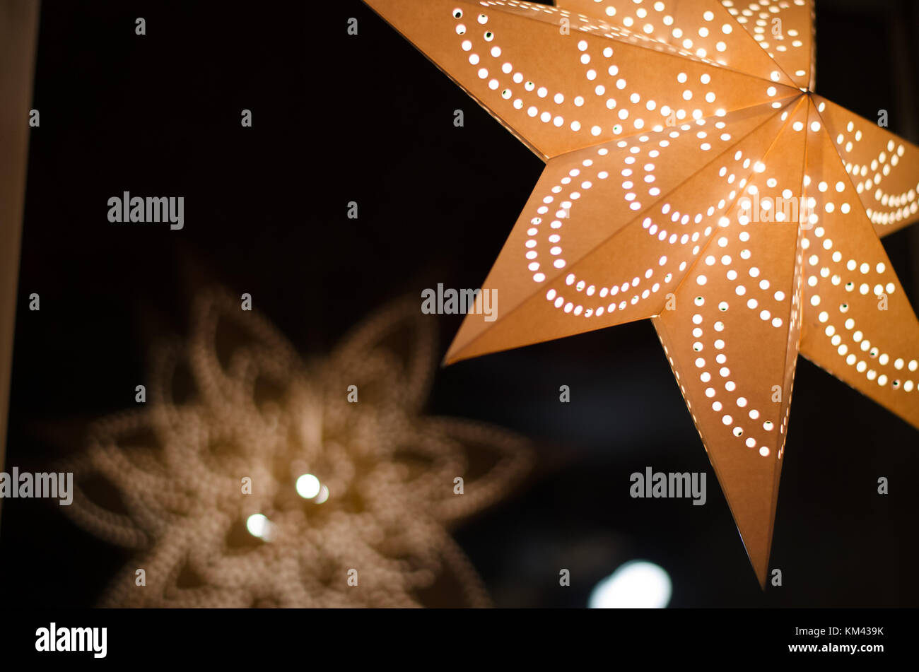 A christmas light shaped as a star in the window during december Stock ...