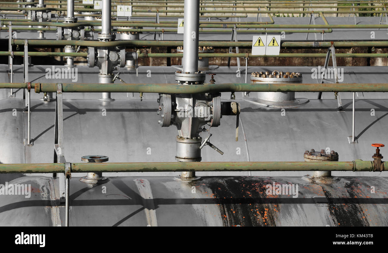 series of large metal tanks for gas storage inside an industrial area ...