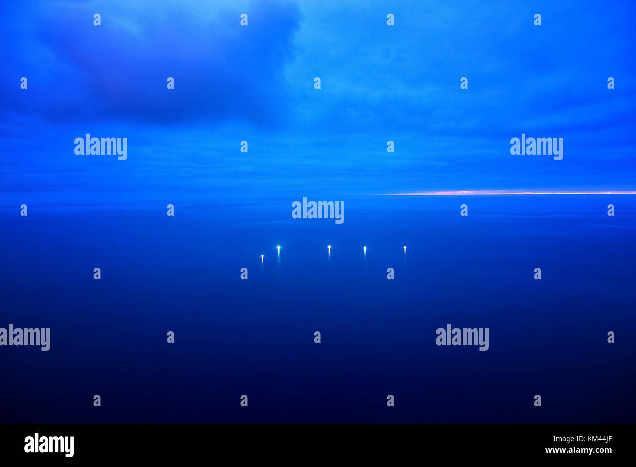 Ocean view with 5 lights in the sea Stock Photo - Alamy