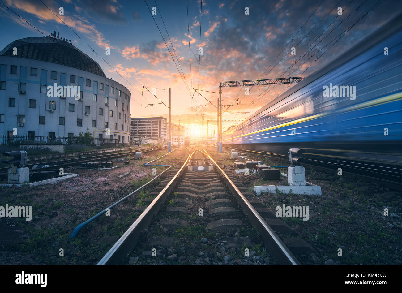 High speed passenger train in motion on railroad track at sunset ...