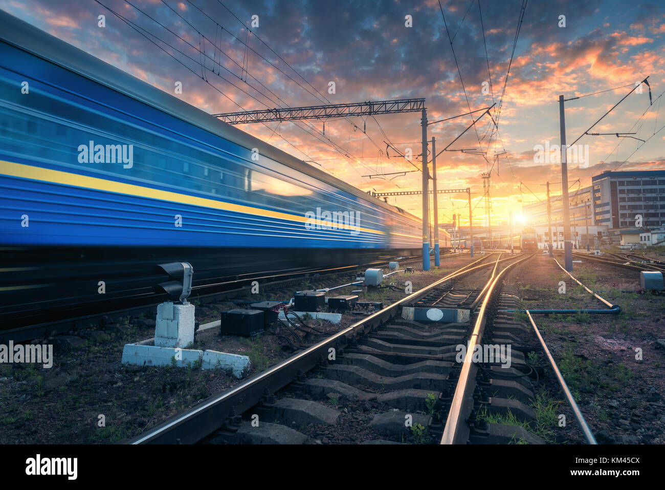 High speed passenger train in motion on railroad track at sunset ...
