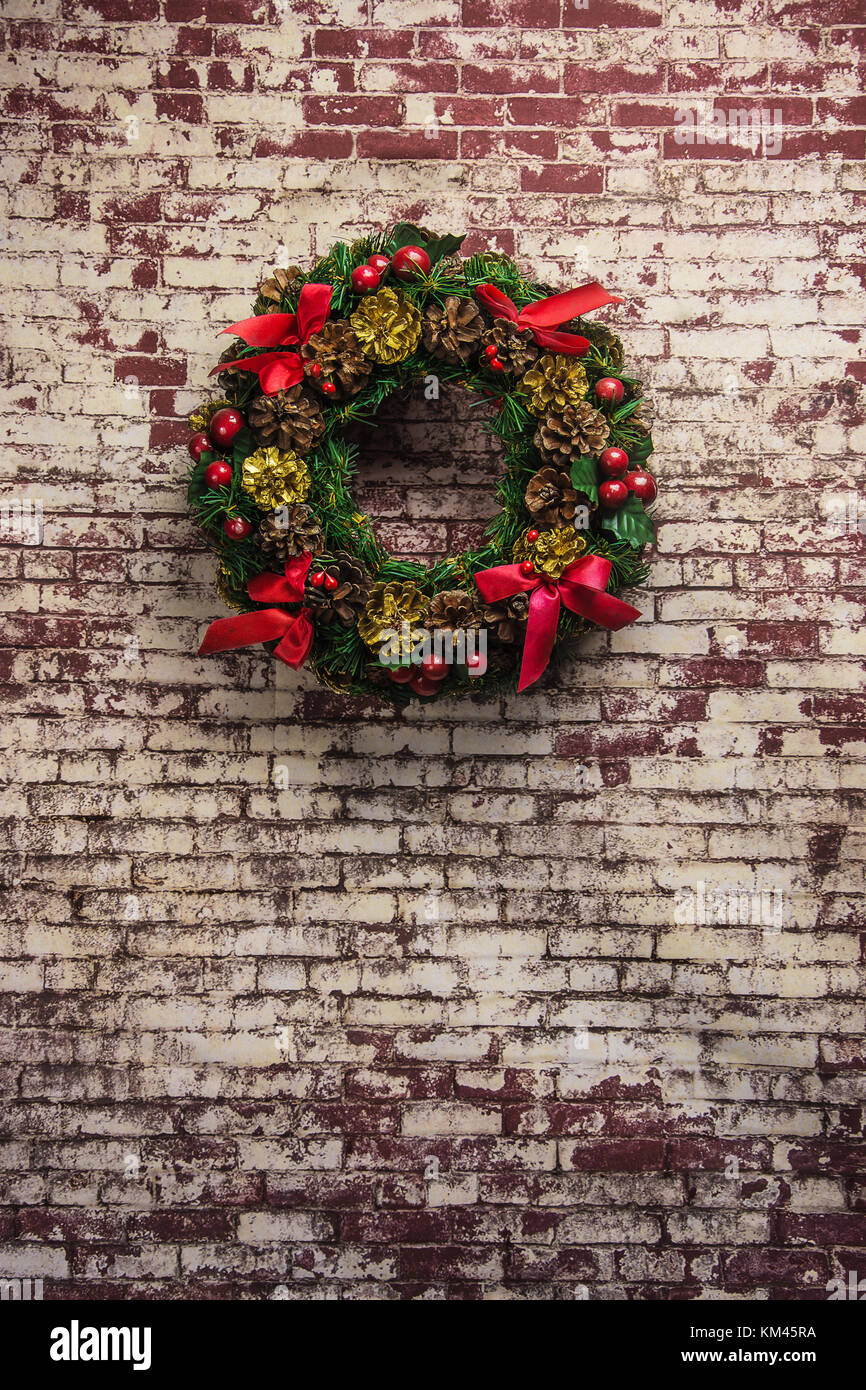 christmas wreath on brick wall background Stock Photo - Alamy
