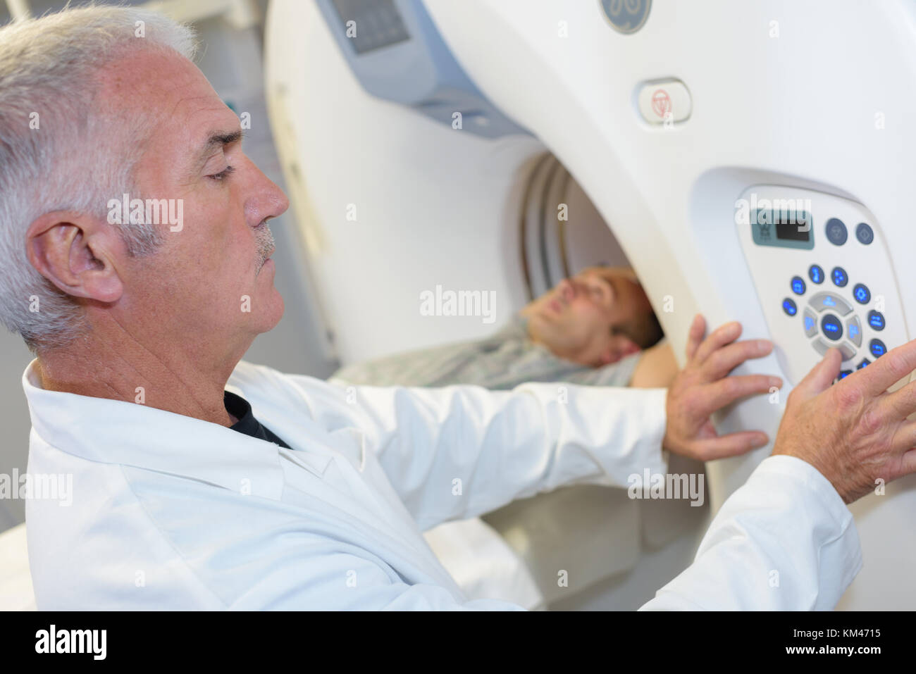 Doctor programming mri scanner Stock Photo - Alamy