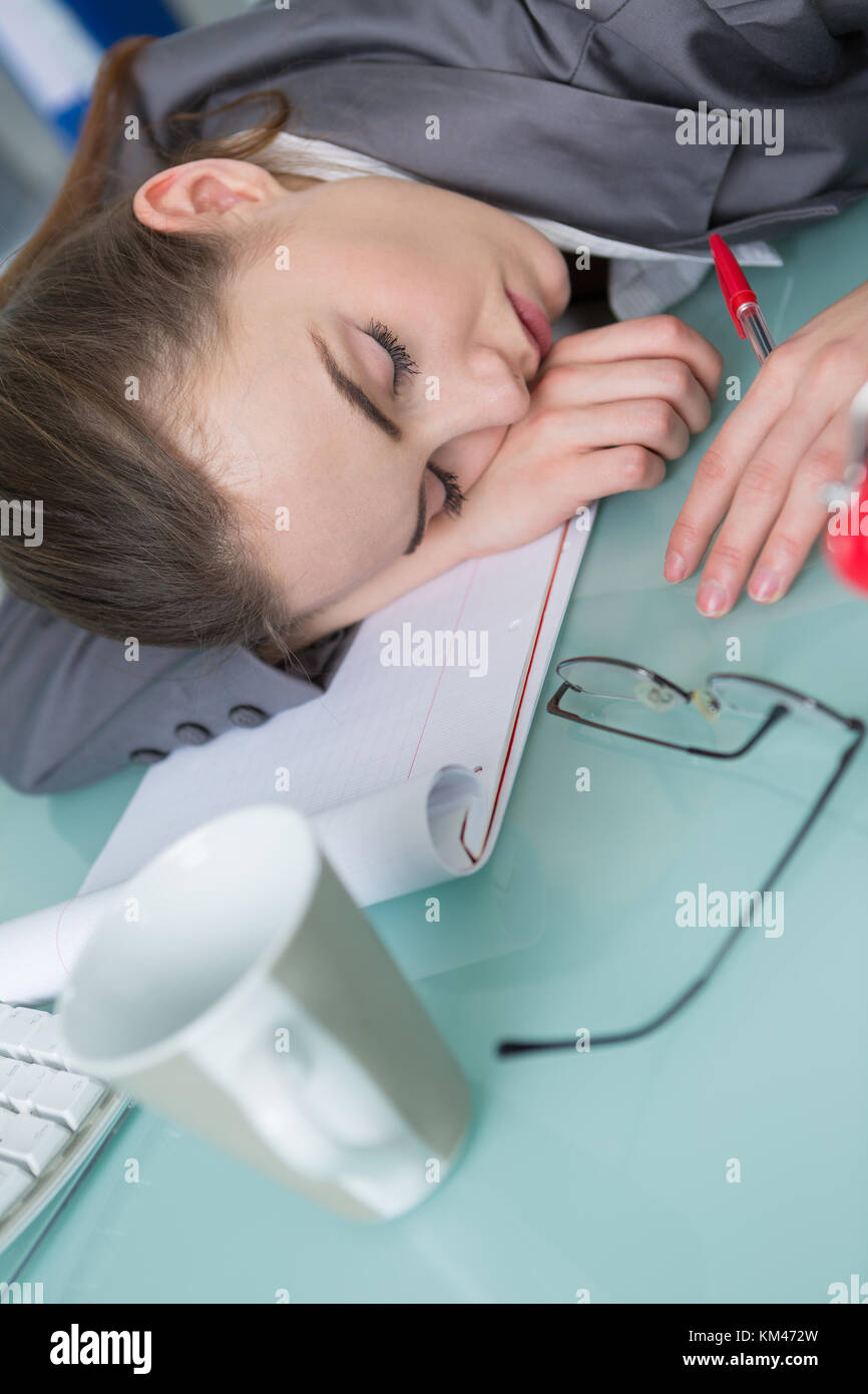Woman fallen asleep at her desk Stock Photo - Alamy
