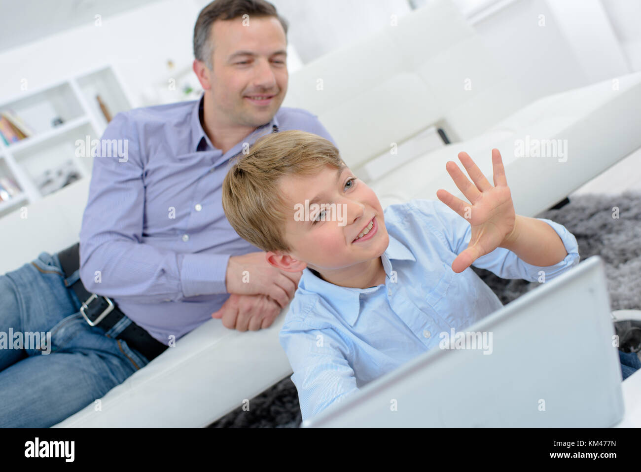Child on computer holding up five fingers Stock Photo - Alamy