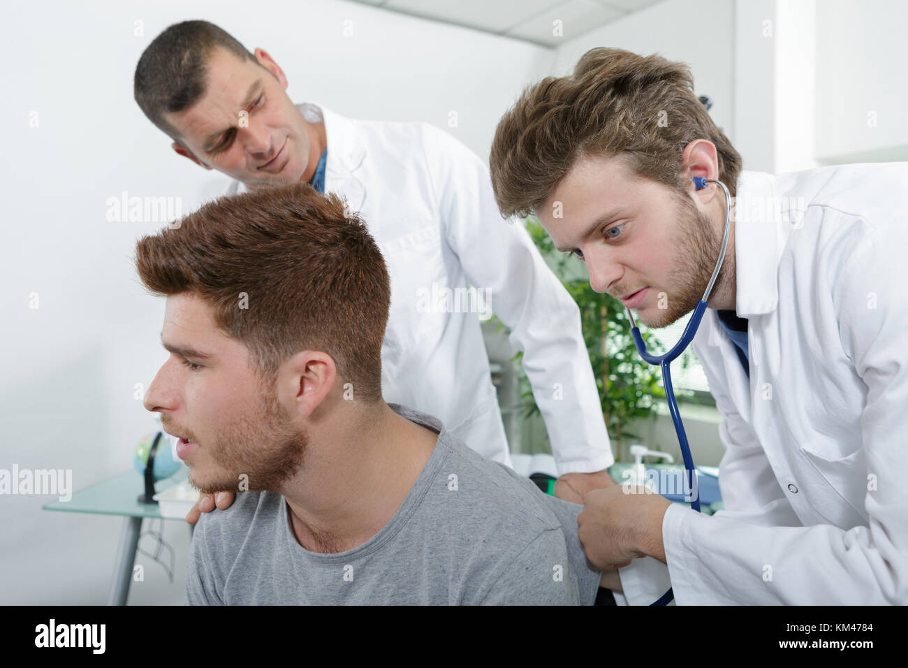 young internist healing patient under experienced doctors surveillance ...