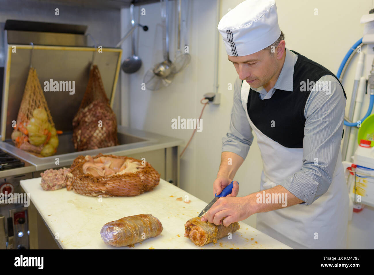 a butcher working Stock Photo - Alamy