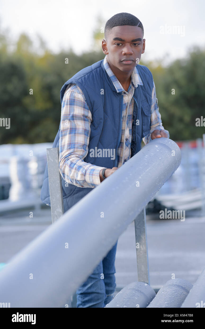 construction worker on site holding pipe Stock Photo - Alamy