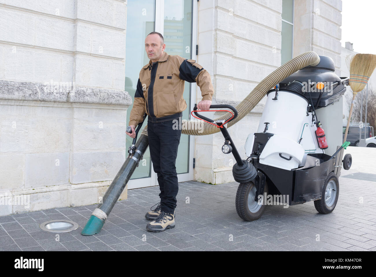 Man using street cleaning machine Stock Photo - Alamy