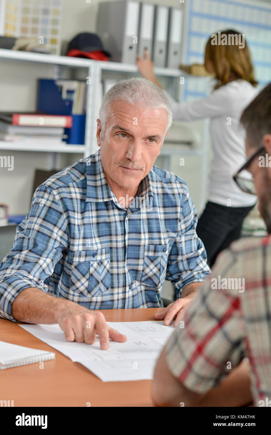 Architect explaning something to client Stock Photo - Alamy