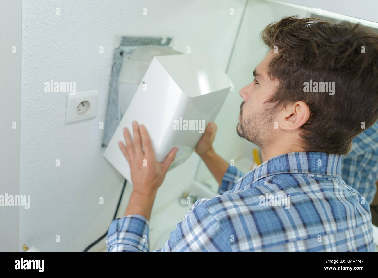 installation of hand-dryer in office Stock Photo - Alamy