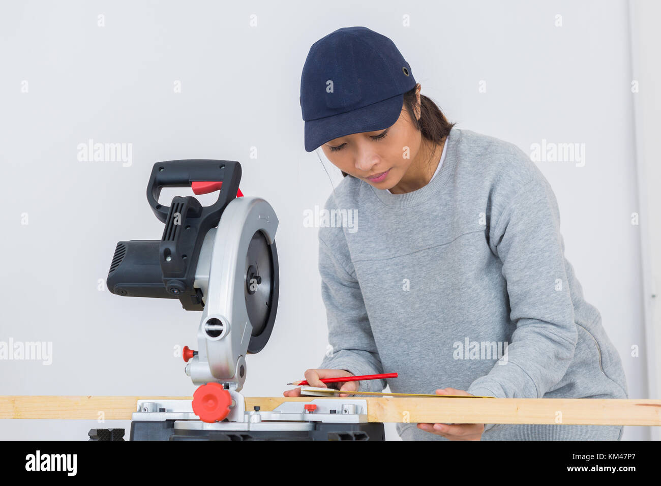 women worker using saw machine to make furniture Stock Photo - Alamy