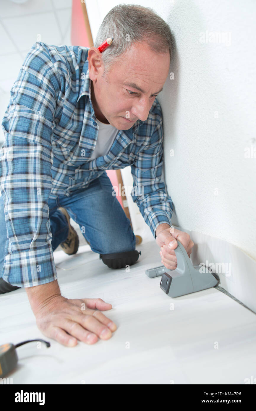pushing the tiles down Stock Photo - Alamy