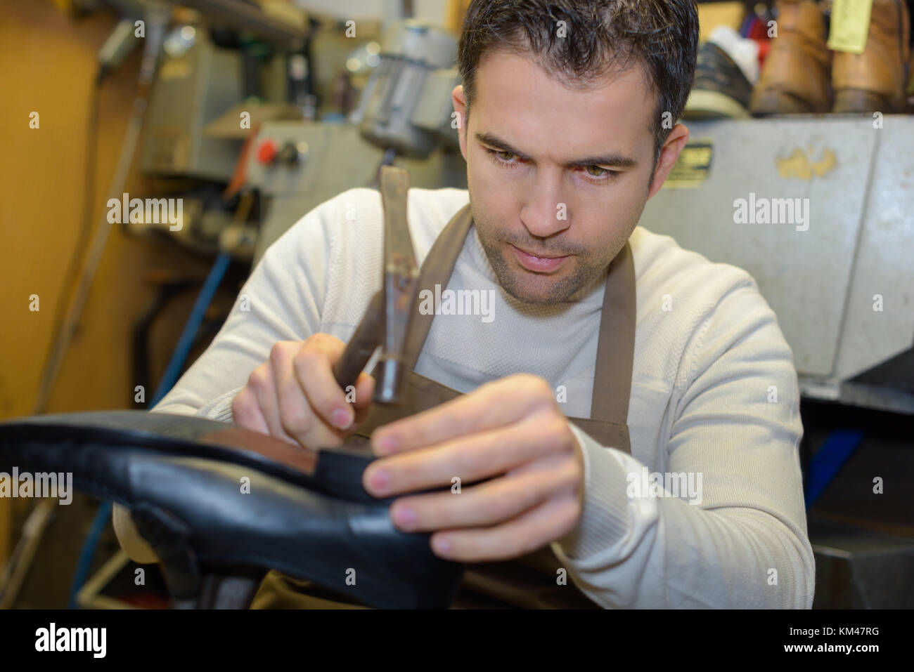 shoe cobbler repairing heel on a pair of shoes Stock Photo - Alamy