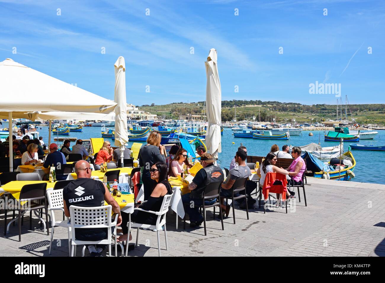 Tourists relaxing at a pavement cafes along the waterfront with ...