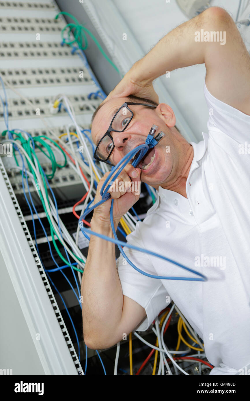 confused it professional with cables in a data center Stock Photo - Alamy