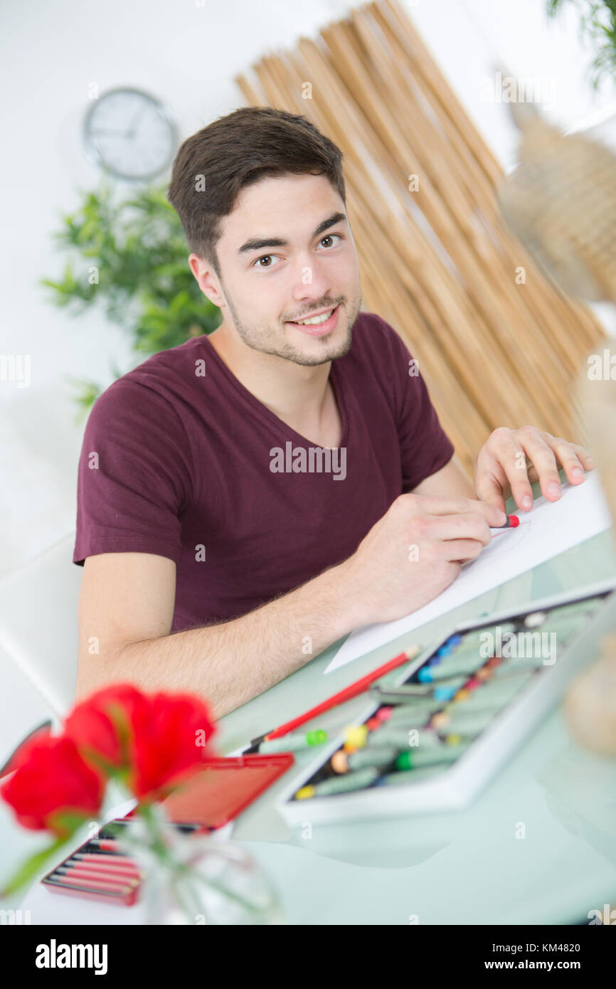 young man drawing pictures in studio Stock Photo - Alamy