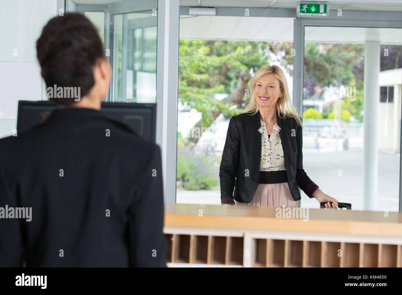 beautiful customer at the reception of a hotel checking in Stock Photo ...