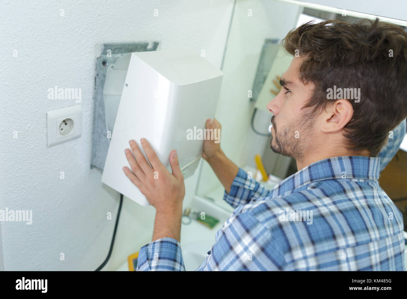 installation of hand-dryer in office Stock Photo - Alamy
