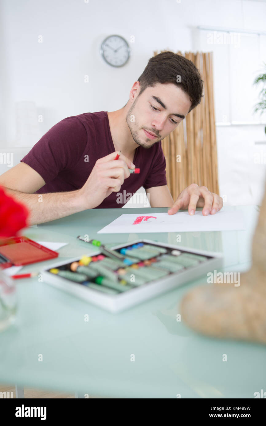 Adolescent male doing art work Stock Photo - Alamy