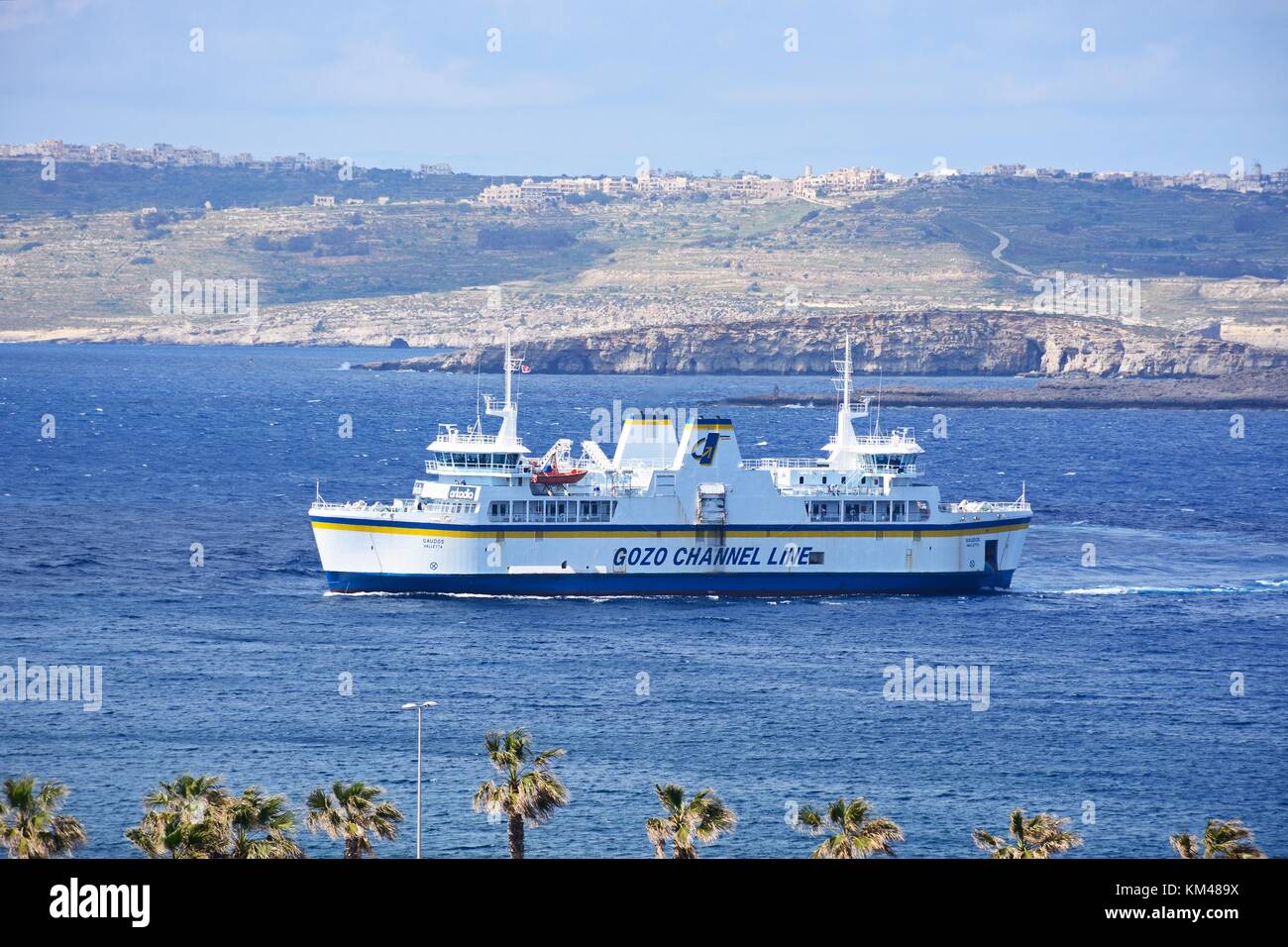 Gozo ferry in the bay with views towards Gozo and Comino, Paradise Bay ...
