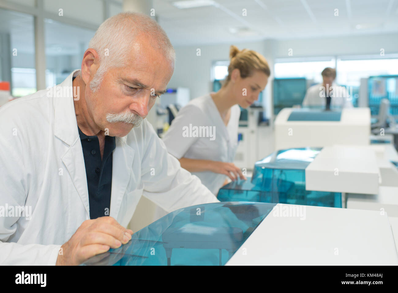elderly scientist using machine on laboratory Stock Photo - Alamy