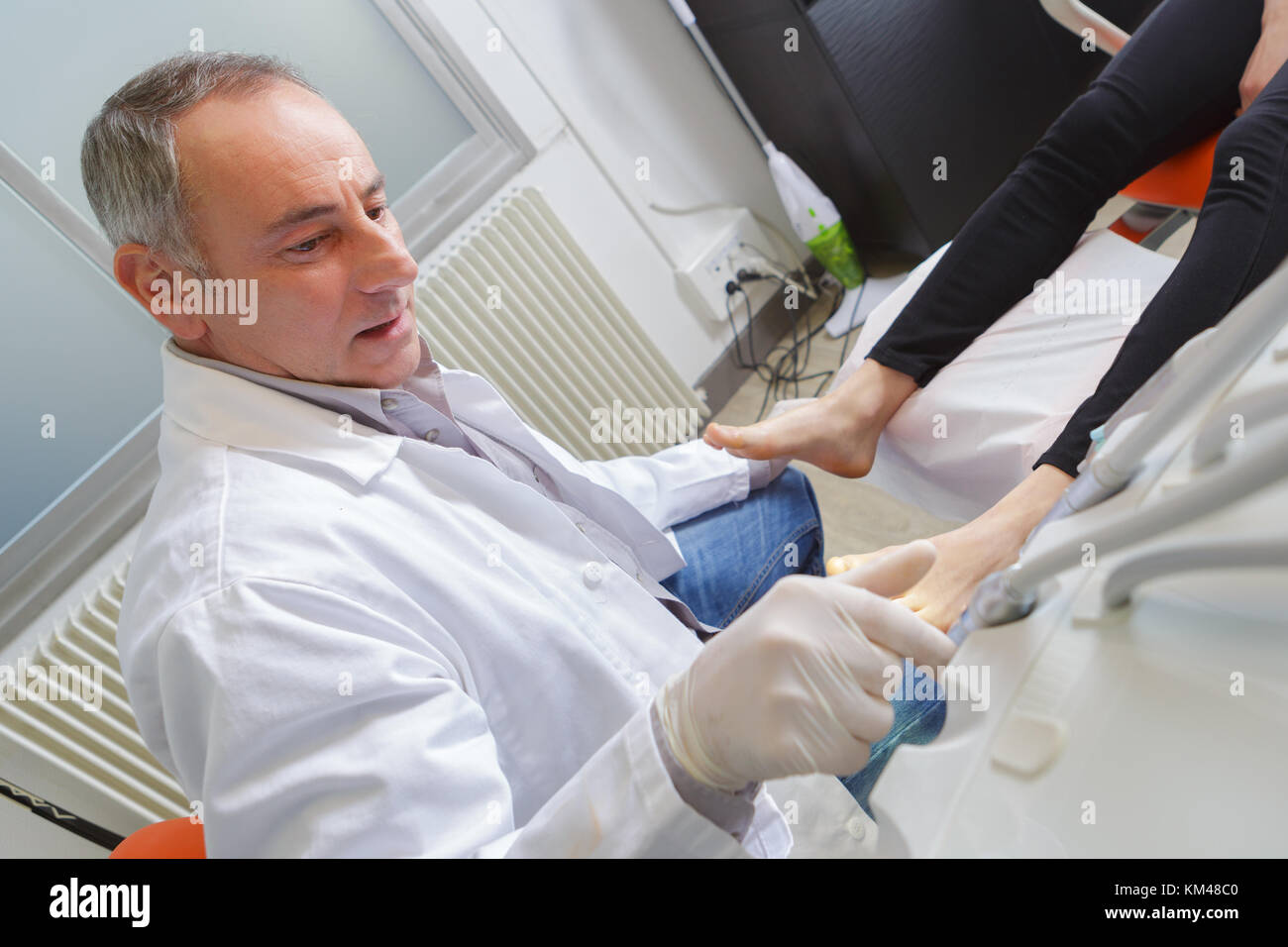 woman receives foot examination from gloved podiatrist Stock Photo - Alamy