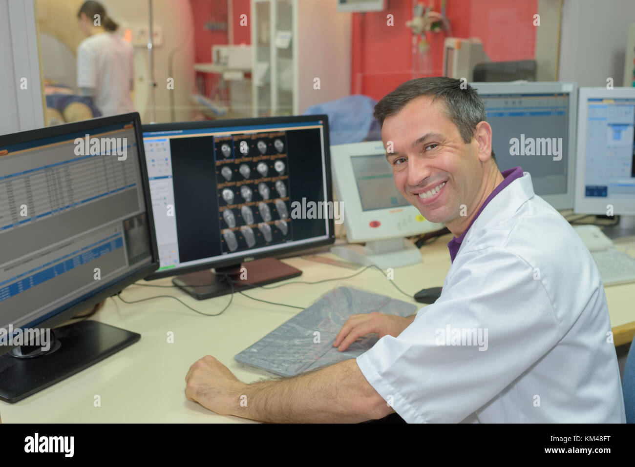 happy male hospital receptionist working Stock Photo - Alamy