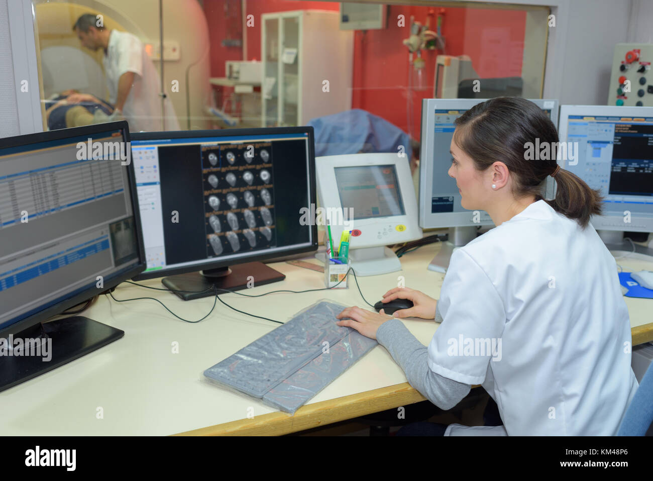 female doctor programming computer for medical scan Stock Photo - Alamy