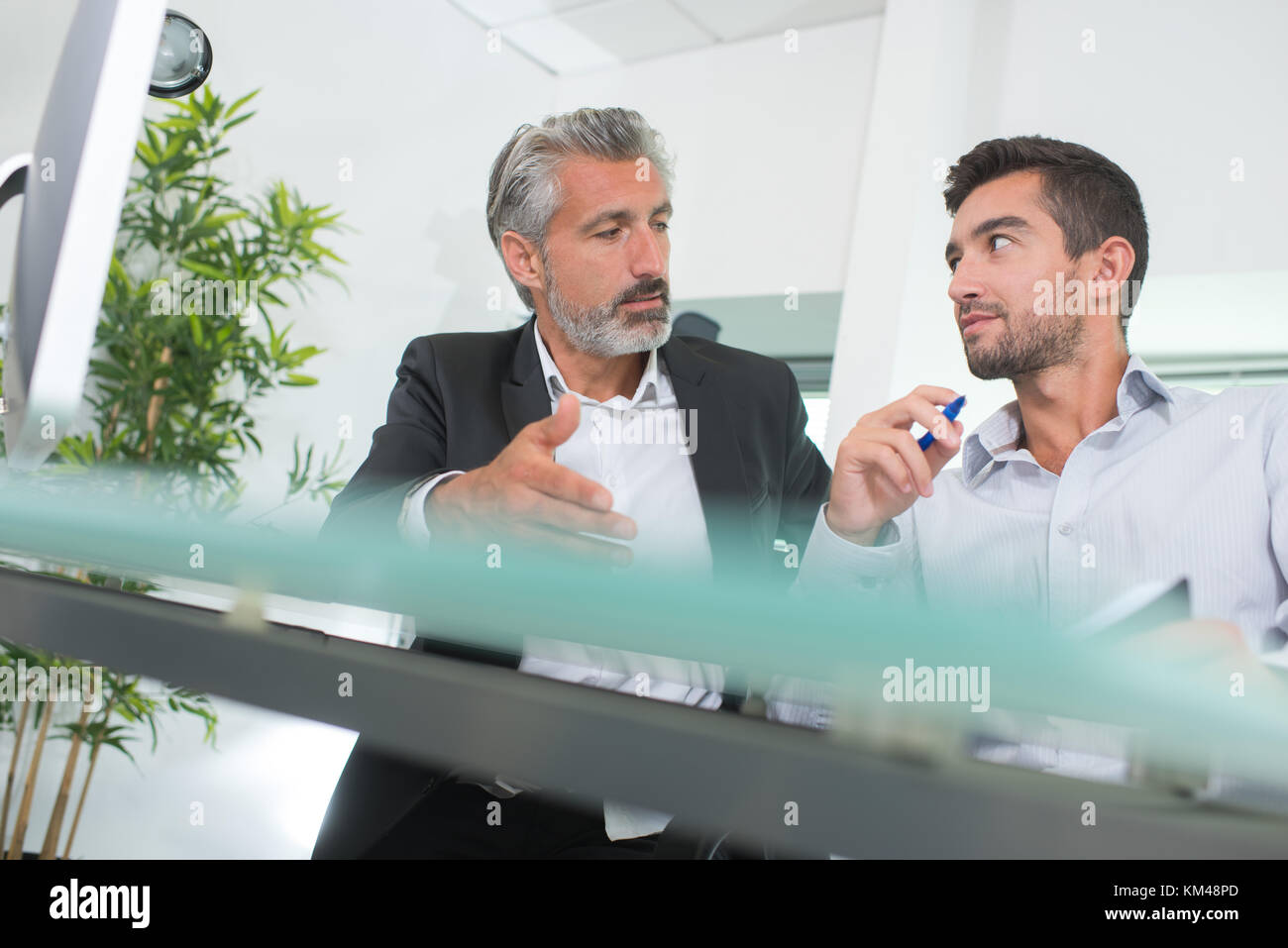 young office professional having a conversation with the boss Stock ...