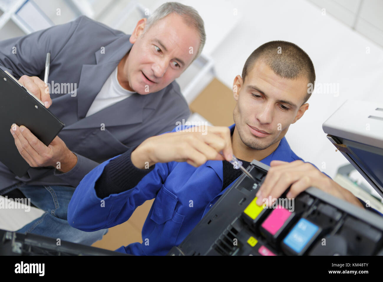 two technicians repairing printer Stock Photo - Alamy