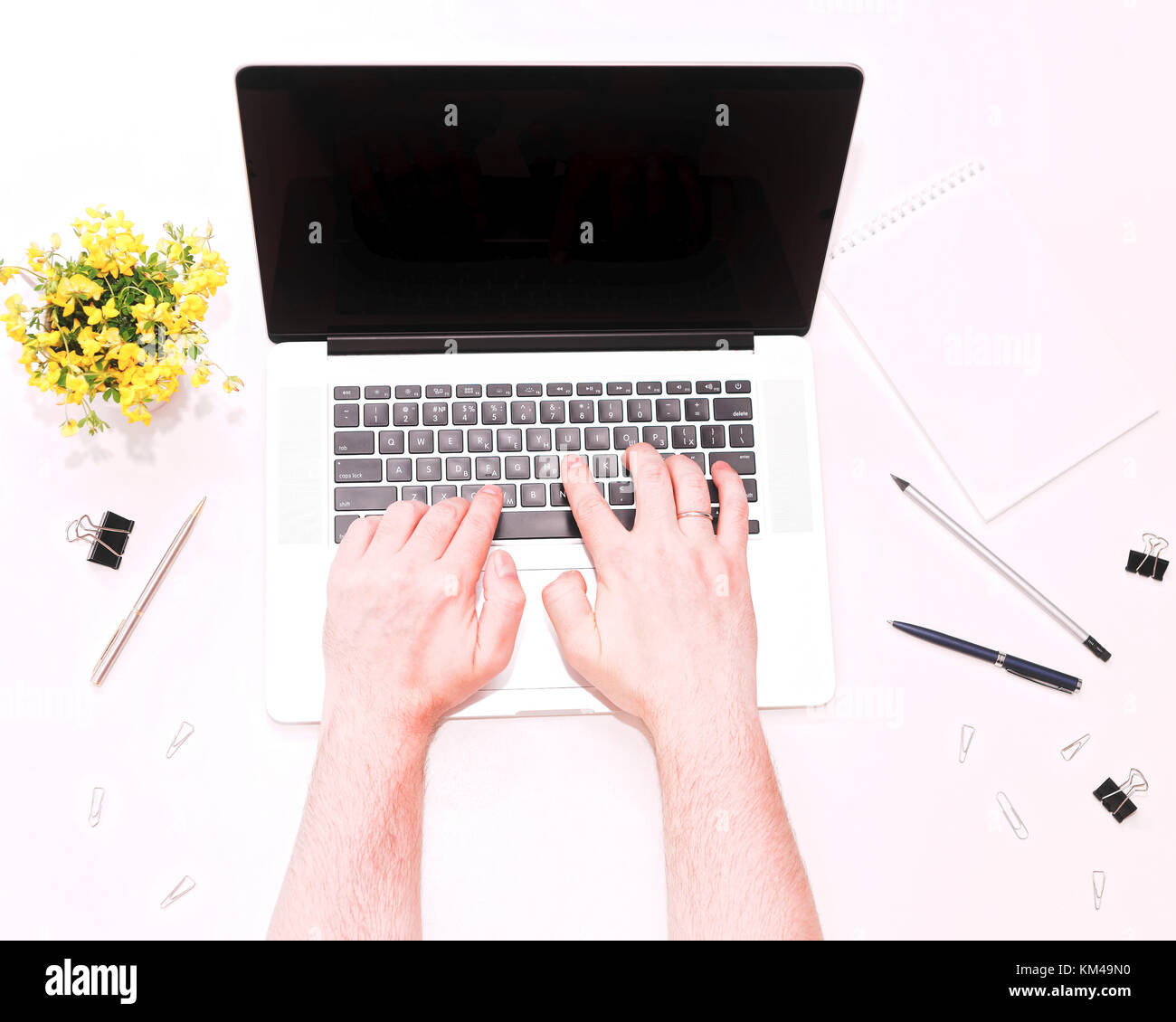 Workspace with woman hands working on laptop keyboard, diary and yellow ...