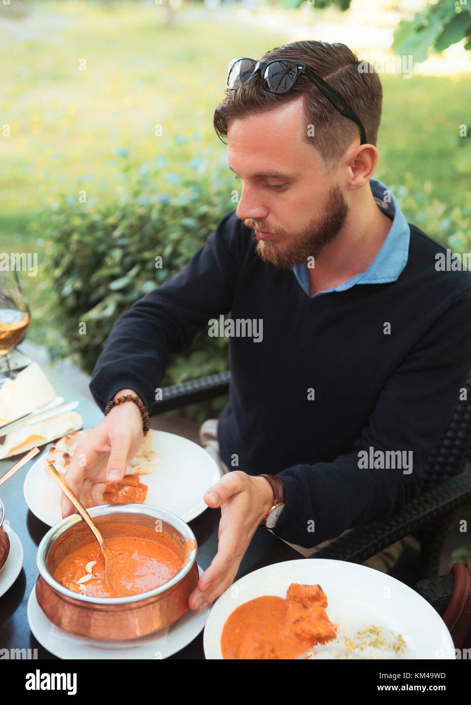 Young man having dinner in a street cafe Stock Photo - Alamy