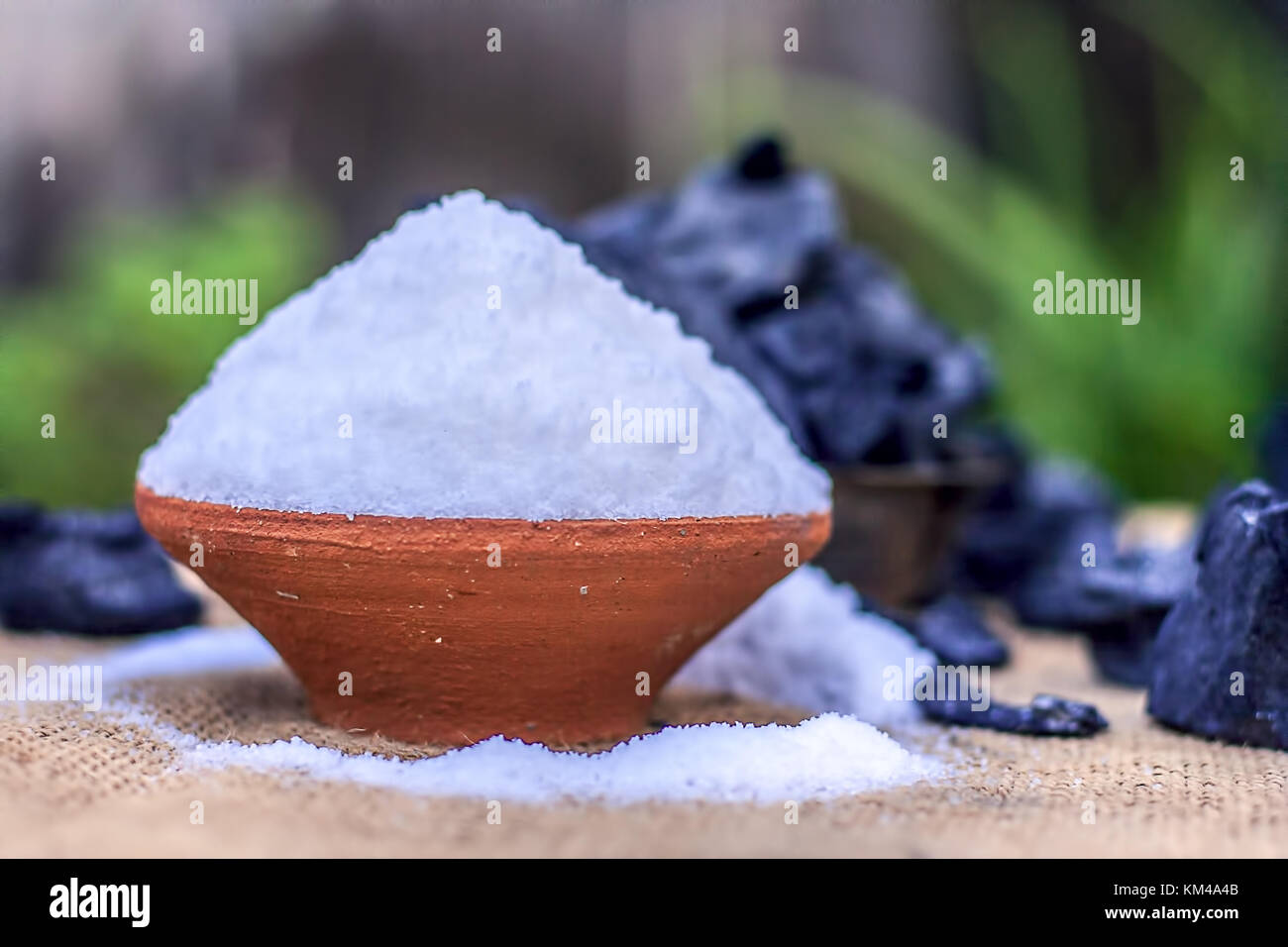 Sodium chloride,Salt in a clay bowl with coal Stock Photo - Alamy