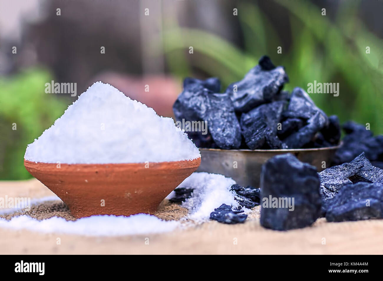 Sodium chloride,Salt in a clay bowl with coal Stock Photo - Alamy