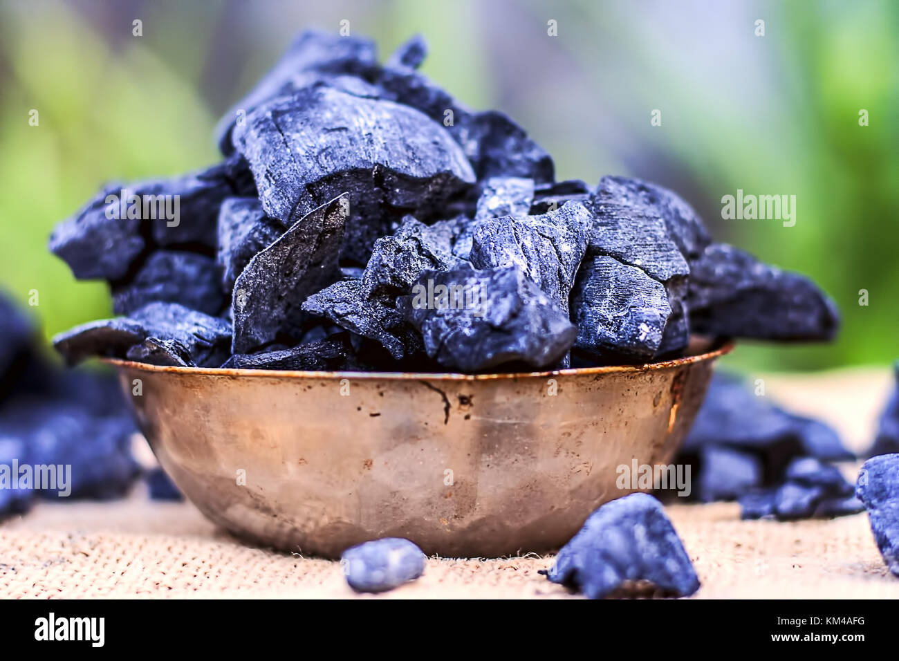 Coal in a rusted bowl on a gunny background Stock Photo - Alamy