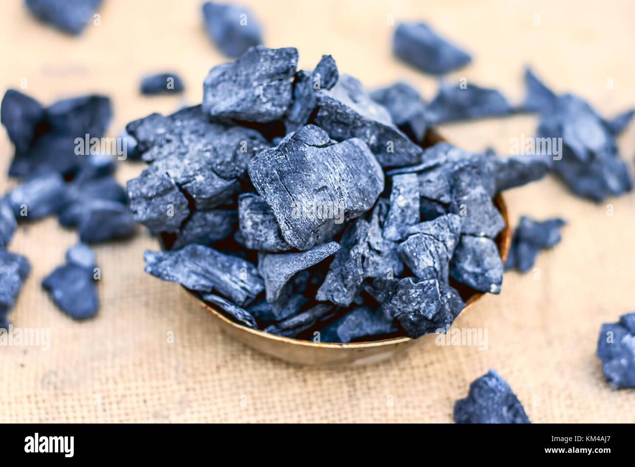 Coal in a rusted bowl on a gunny background Stock Photo - Alamy