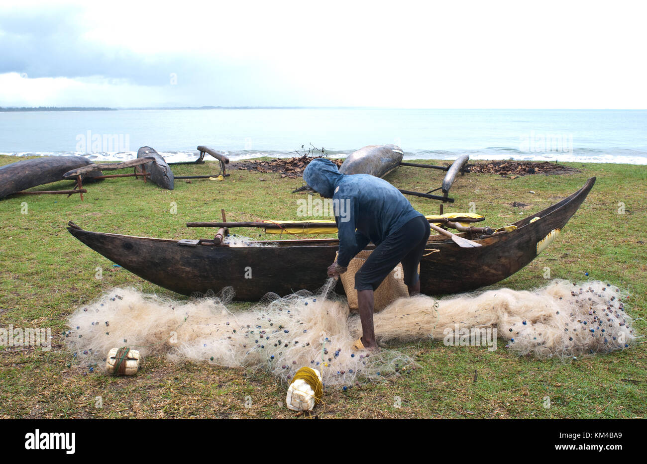 Fisherman packing his fishing net ( Madagascar Stock Photo - Alamy