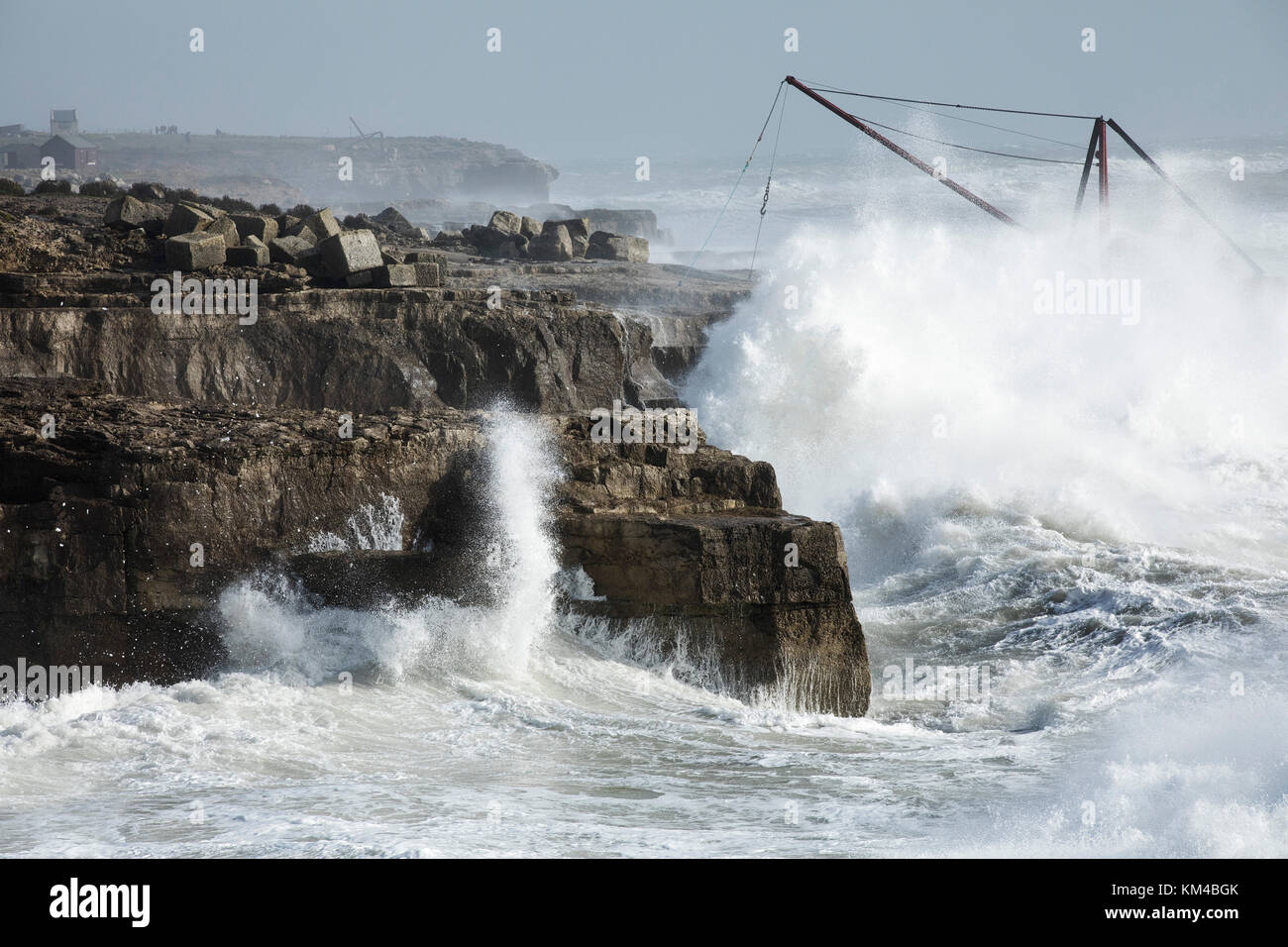 Storm Brian breaking over the red crane Portland Bill, Dorset, England ...