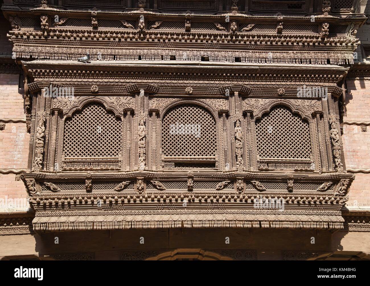Filigree carvings decorate this precious window at the old royal palace ...