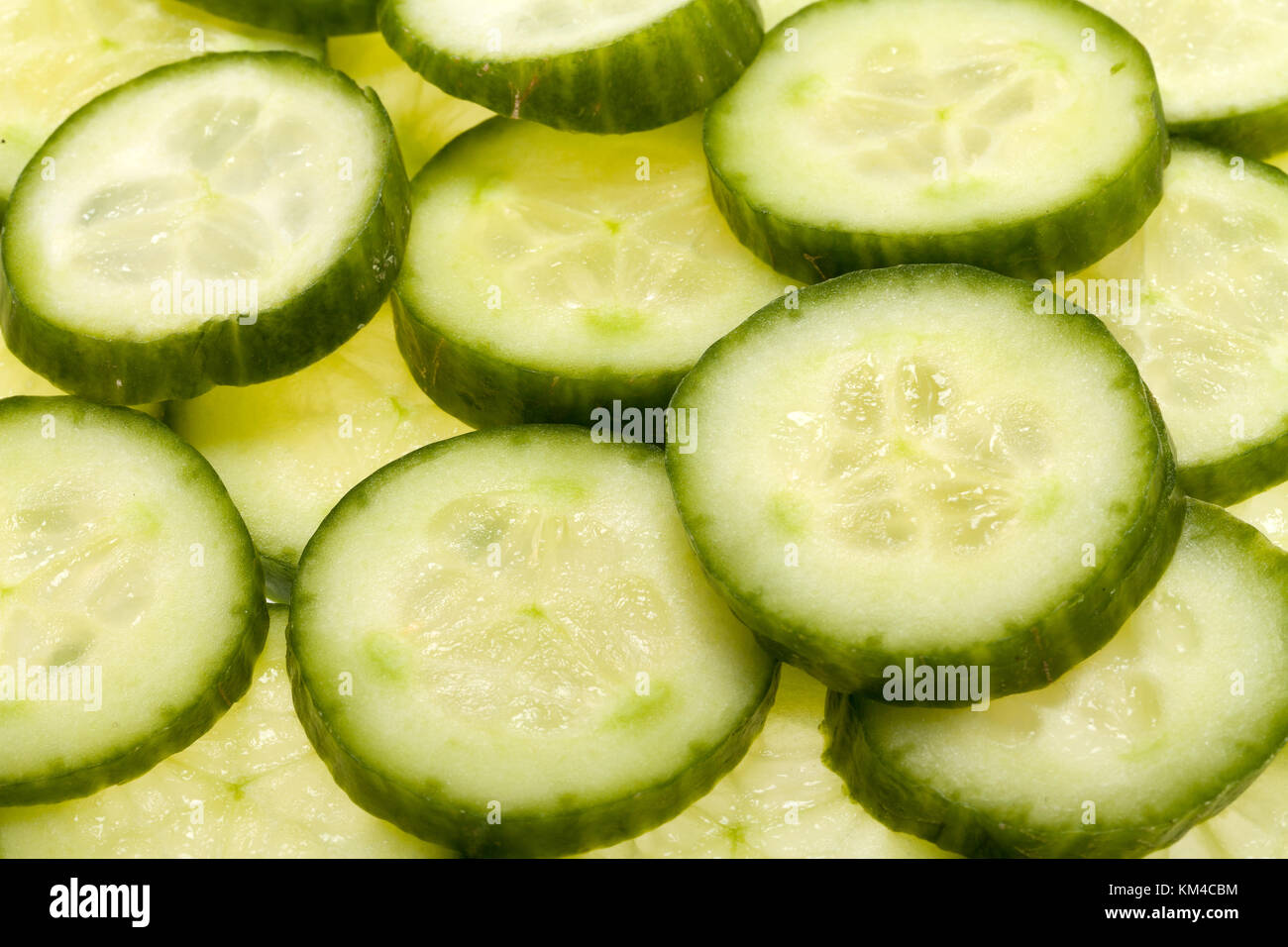 Freshly sliced cucumber isolated on white background Stock Photo - Alamy