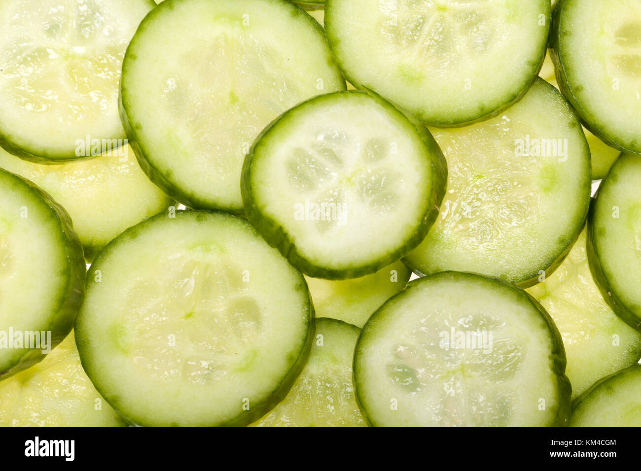 Freshly sliced cucumber isolated on white background Stock Photo - Alamy