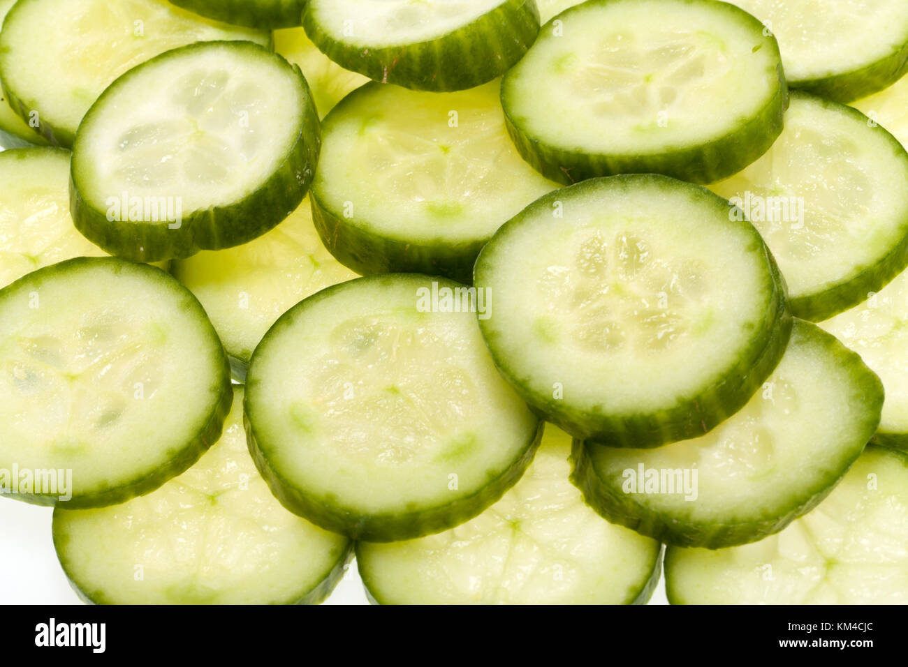 Freshly sliced cucumber isolated on white background Stock Photo - Alamy