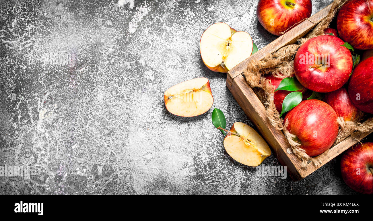 Red apples in an old box. On rustic background Stock Photo - Alamy