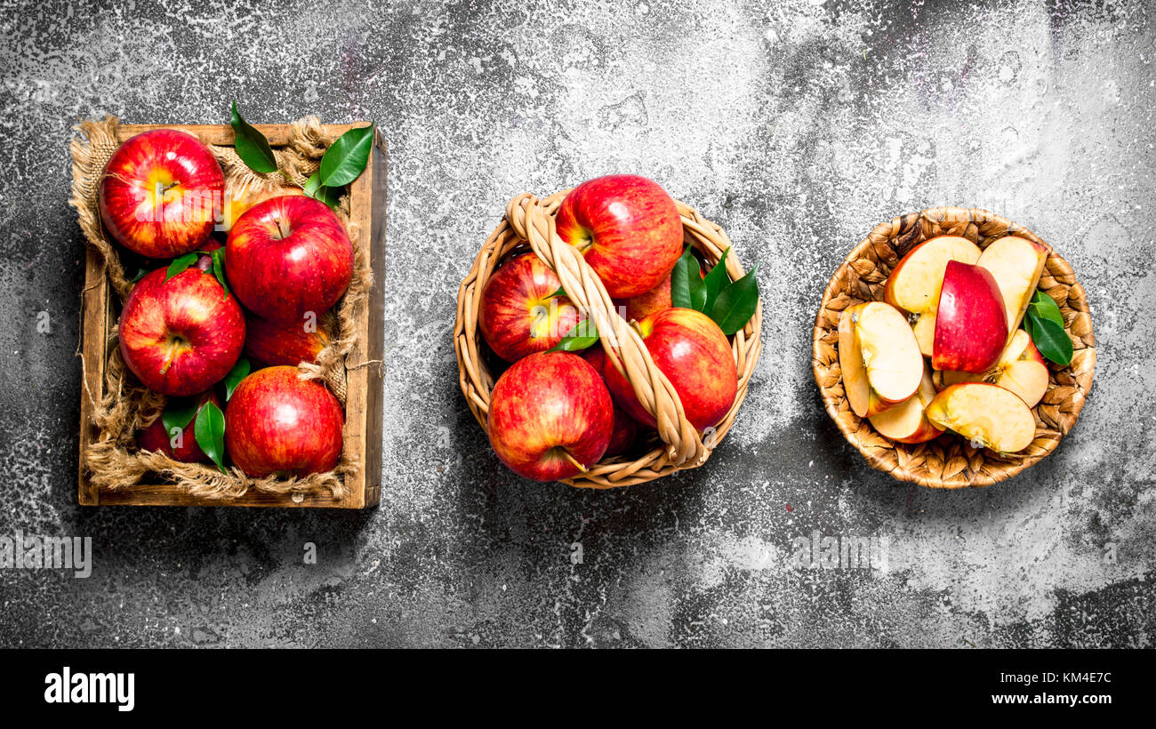 Red apples in the box and baskets. On rustic background Stock Photo - Alamy
