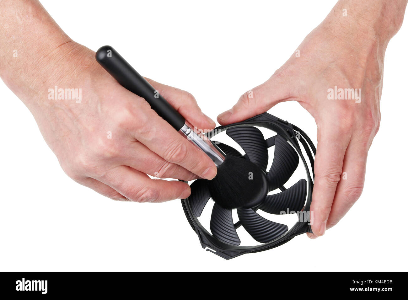The technician engineer cleans a computer fan from dust with a soft ...