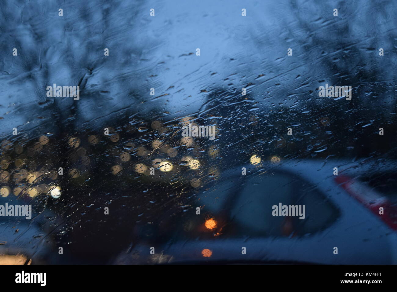 Street lights captured through a rain covered window with the focus ...
